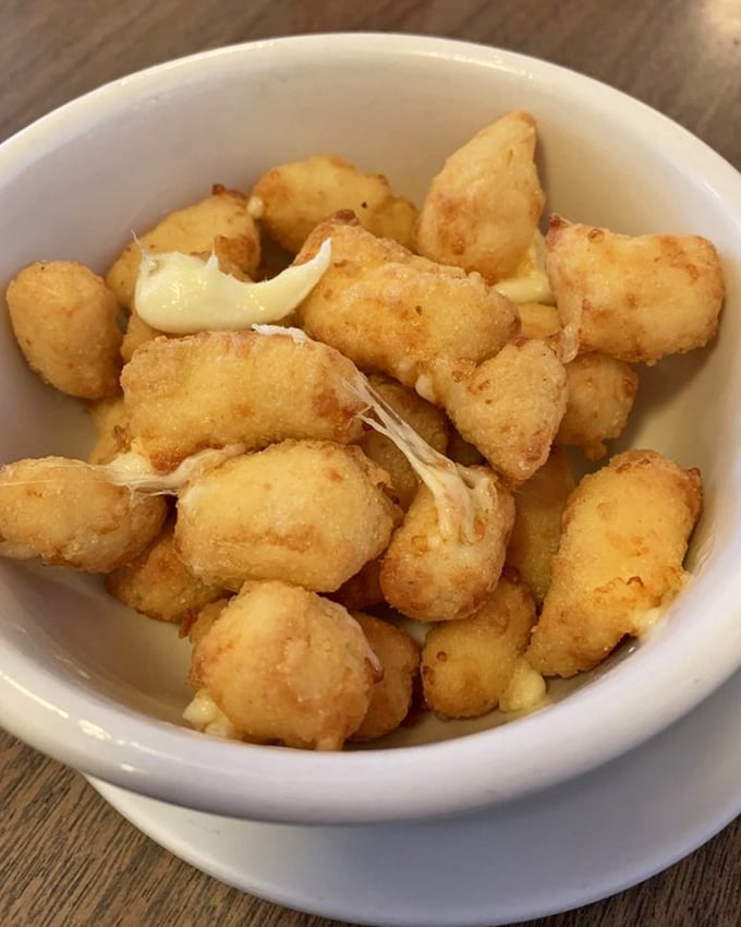Wisconsin's beloved cheese curds, golden-fried to squeaky perfection—the state's official way of saying "vegetables are overrated."