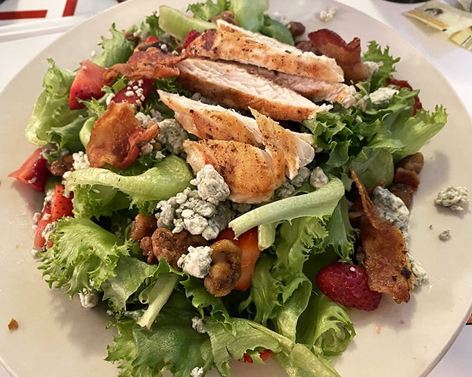 This chicken salad doesn't just check the "healthy option" box – it celebrates it with vibrant greens, blue cheese crumbles, and protein that wasn't sacrificed for virtue.