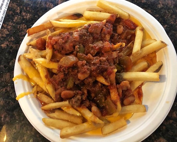 Fries transformed into a complete meal. Golden potatoes swimming in chili and cheese—a delicious reminder that sometimes more is more.