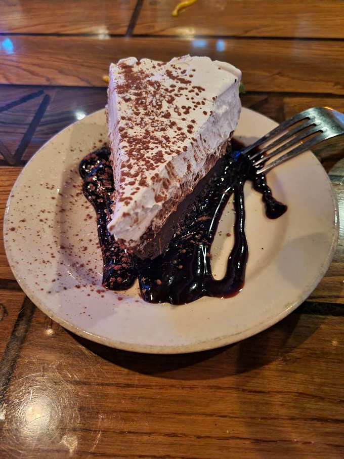 Chocolate mousse pie with a cloud of whipped cream—the kind of dessert that makes you suddenly discover room in your stomach you didn't know existed.
