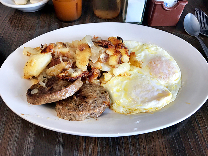 The breakfast plate that launched a thousand satisfied sighs—eggs, potatoes, and sausage in perfect harmony like a culinary power trio.