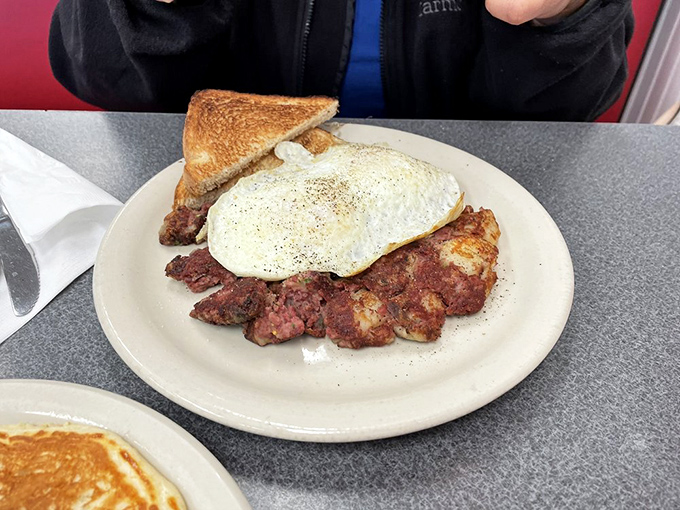 Corned beef hash crowned with a perfect sunny egg. The crispy edges of that hash are what breakfast dreams are made of.