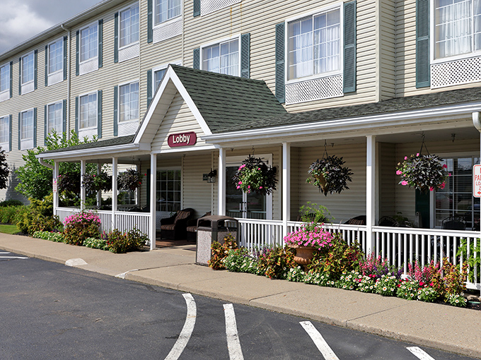 The Village Inn's porch beckons with hanging baskets and rocking chairs—hospitality that begins before you even reach the front desk.