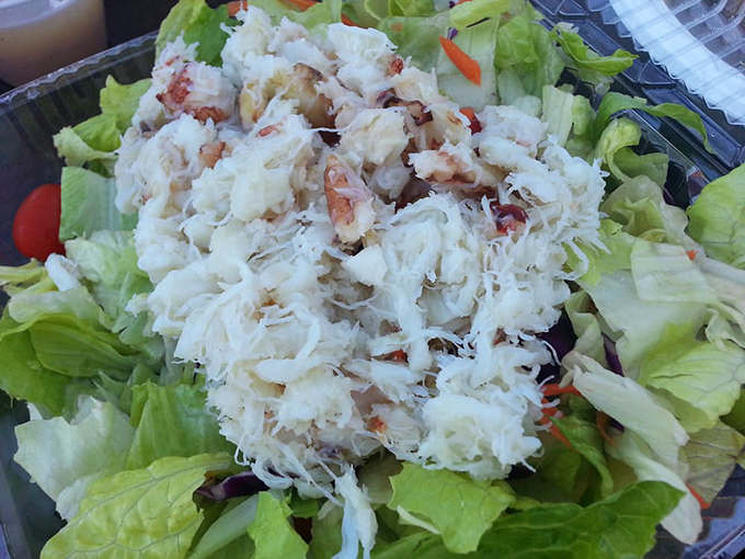 Crab salad that's all crab, no filler—perched atop crisp greens like the seafood royalty it is. Simplicity that lets quality shine.