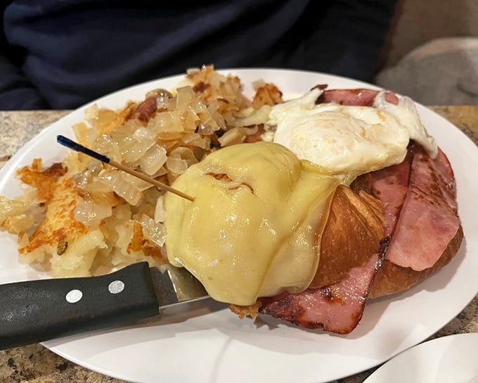 The breakfast croissant sandwich – where ham, egg and cheese perform a perfect trio, with crispy hash browns that deserve their own standing ovation.