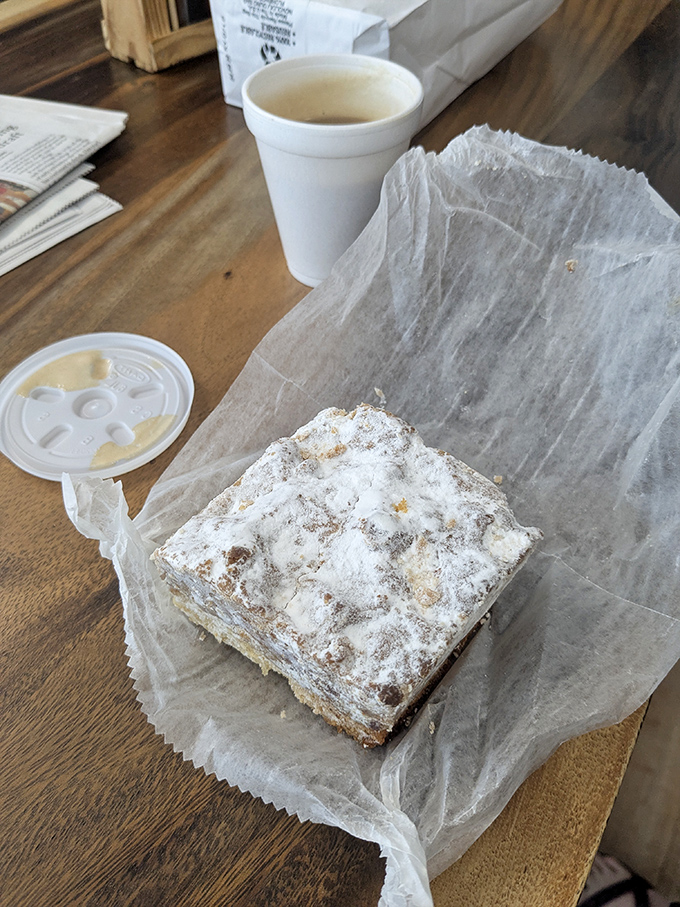 The powdered sugar-dusted crumb cake isn't trying to be Instagram famous—it's too busy being delicious in its simple, old-school bakery perfection.