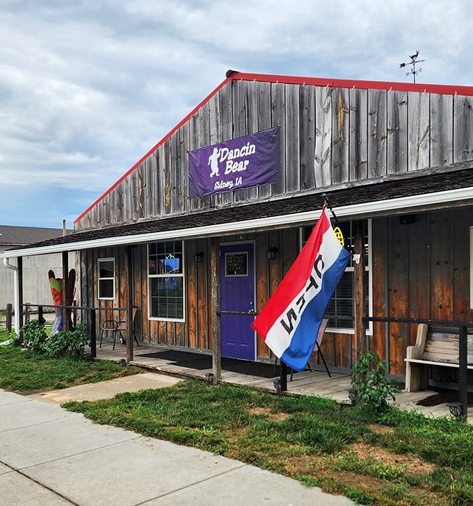 The Dancin' Bear's rustic wooden exterior and purple door promise homestyle comfort and local flavor—the kind of place where regulars have "the usual."