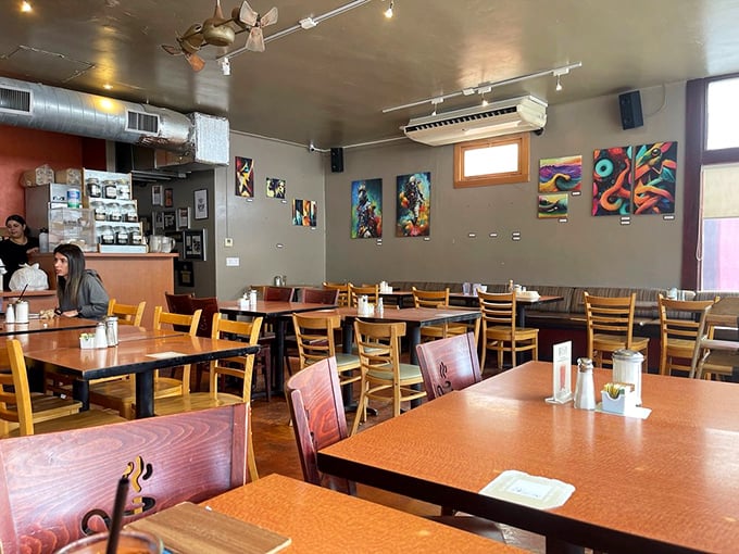 Local art adorns walls while wooden chairs invite lingering conversations—the perfect backdrop for morning revelations over coffee refills.