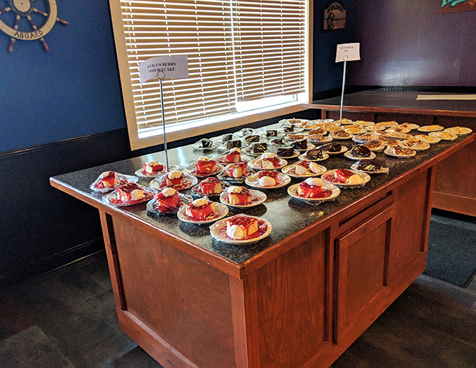 The dessert table—where diet plans go to die happily. Those strawberry shortcakes stand in formation, waiting to deliver their sweet finale.