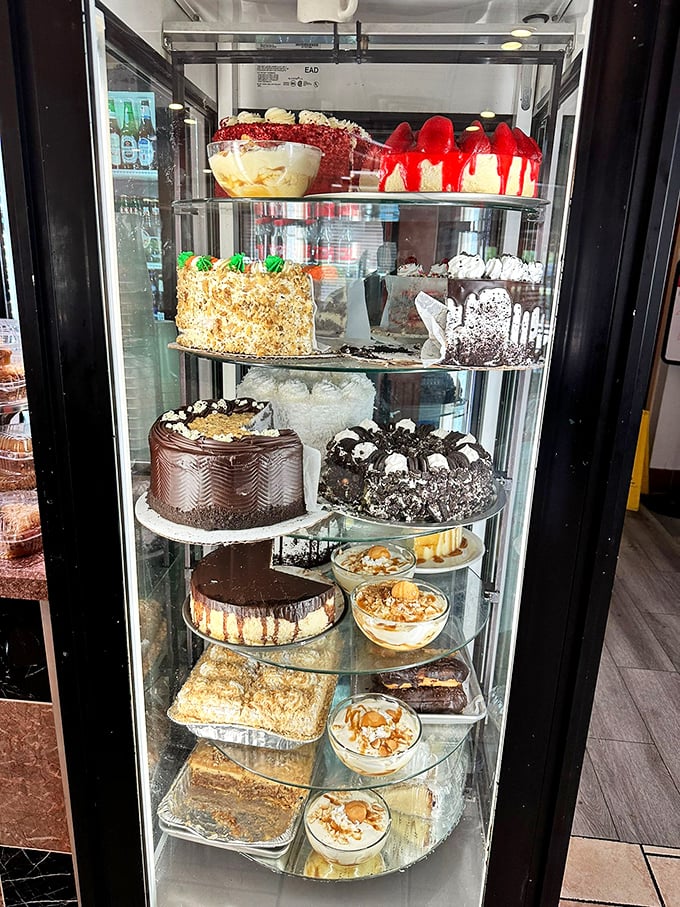 The dessert case—a glass-enclosed museum of temptation where willpower goes to die and "I'll just have a bite" becomes fiction.