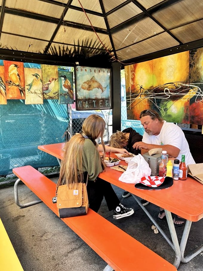 Outdoor seating under colorful art proves that barbecue tastes even better with a side of California sunshine and conversation. 