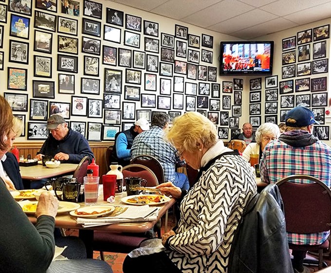 Where generations gather to share stories over eggs and toast. The wall of photos watches approvingly as new memories form.