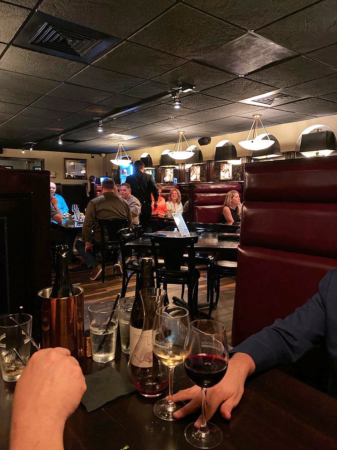 High-backed booths creating intimate dining nooks – where deals are sealed and anniversaries properly celebrated.