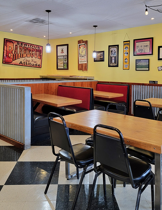 Red booths against corrugated metal with a "Serious Barbecue" sign overhead—they're not just feeding you, they're setting a mood.