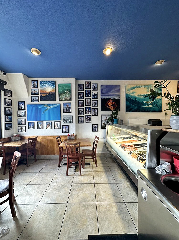 The dining room's blue ceiling and wave artwork create an underwater vibe. It's like eating in Neptune's casual dining room, where fishing photos replace family portraits.