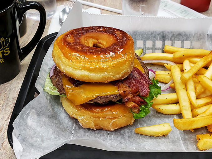 The donut burger—where breakfast and lunch stop fighting and fall in love. Your cardiologist won't approve, but your taste buds will write thank-you notes.