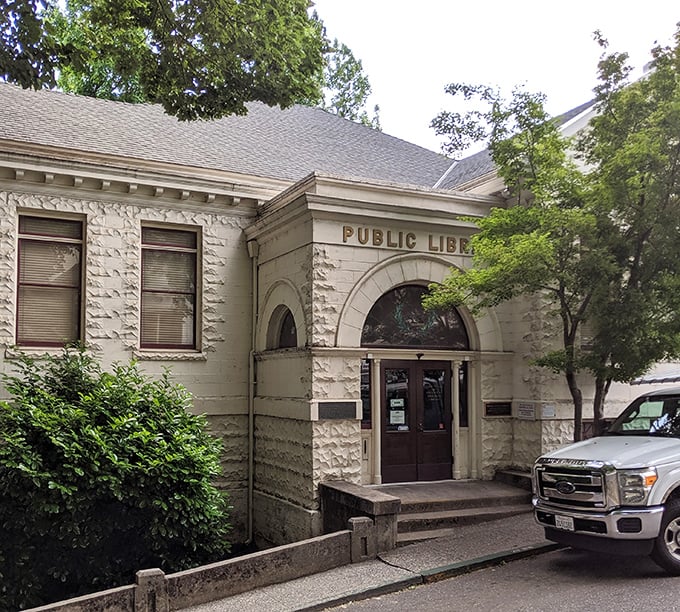 Nevada City’s historic library welcomes visitors with timeless charm, inviting book lovers to explore stories within its peaceful, tree-lined setting.