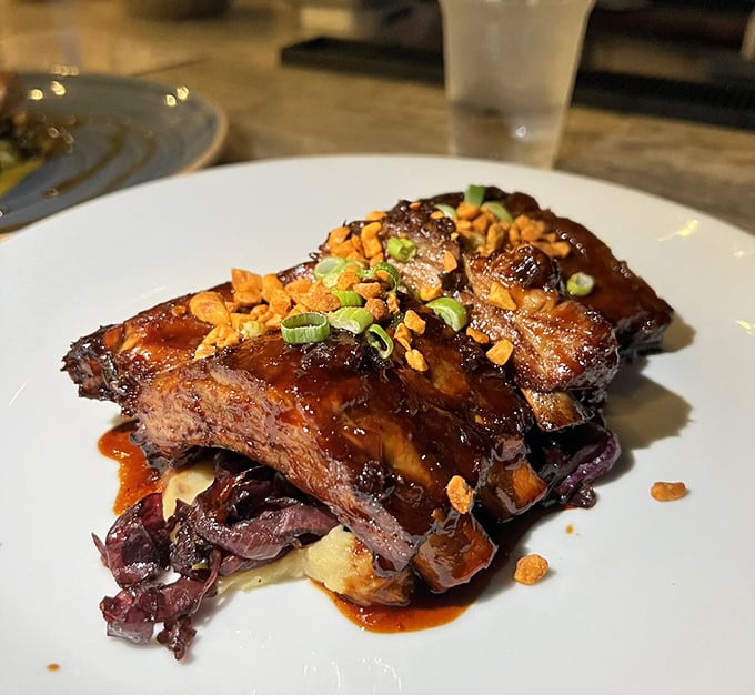 These ribs aren't just falling off the bone—they're diving off with Olympic precision into a pool of glaze that deserves its own medal.