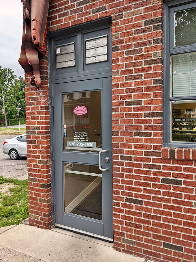 The modest entrance belies the extraordinary treasures within – like finding a portal to dessert paradise behind an ordinary brick facade.