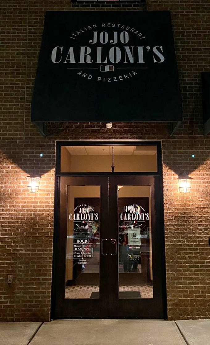 By night, the entrance glows with promise—like a portal to a world where calories don't count and Monday morning doesn't exist.