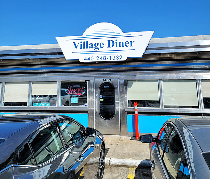 That iconic Village Diner sign against a blue sky – like a beacon of breakfast hope on even the cloudiest Ohio morning.