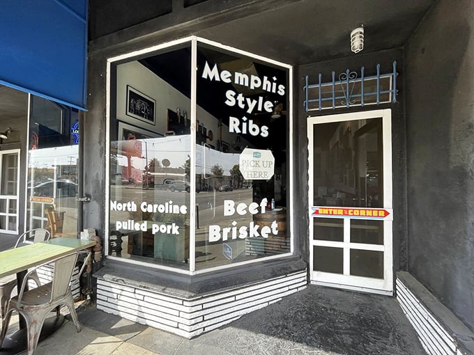 The window proudly announces its regional allegiances: Memphis ribs, Carolina pulled pork, and Texas brisket—a United Nations of barbecue.