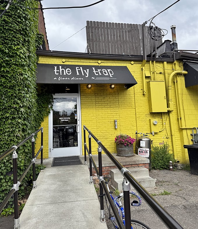 The yellow brick exterior with its accessible entrance doesn't just welcome you—it practically pulls you in with the promise of culinary delight.