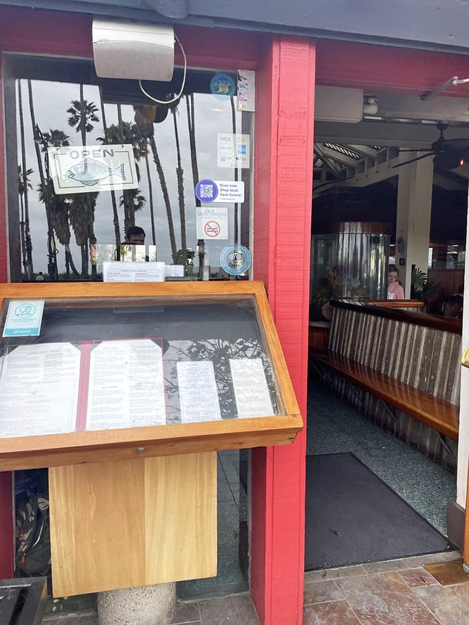 The "OPEN" fish sign isn't just cute—it's the maritime equivalent of a lighthouse, guiding hungry sailors to safe harbor.