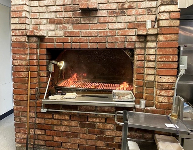 The brick hearth where steaks meet their destiny. This isn't just cooking—it's a primal ritual performed with the respect great meat deserves. 