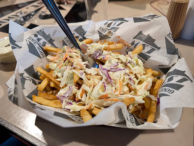 Fries wearing a creamy slaw hat—because naked fries are so last century. This loaded masterpiece demands both a fork and your full attention.