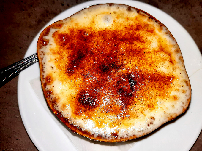 This isn't just French onion soup—it's a bubbling cauldron of comfort with a bronzed cheese lid that demands to be broken into with reverent respect.