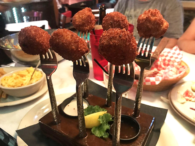 Fried scallops elevated to an art form—each one perched on its own fork pedestal, creating a bouquet of golden-brown deliciousness that's almost too pretty to eat. Almost.