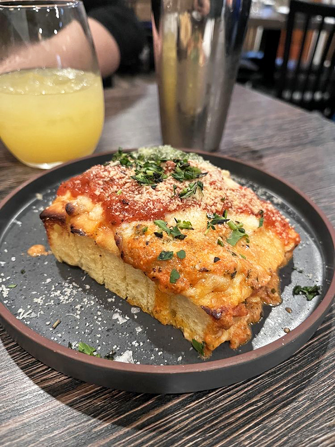 Not just garlic bread, but a revelation of crispy exterior giving way to soft, cheesy interior – carbs elevated to art form.