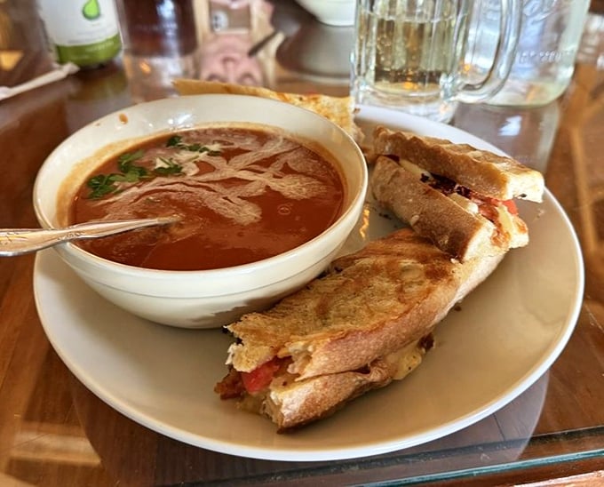 A grilled cheese sandwich that's achieved golden perfection meets its soulmate – a bowl of tomato soup that's begging for that first dunk.