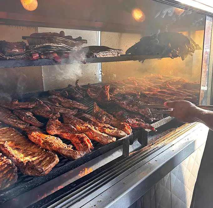 The aquarium smoker—Chicago's contribution to barbecue architecture—where meat transforms from ordinary to extraordinary through smoke and time.