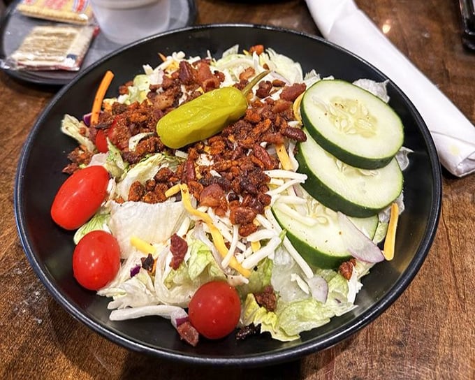A salad that doesn't apologize for being at a barbecue joint. Those bacon bits aren't just toppings—they're tiny ambassadors from the meat department.
