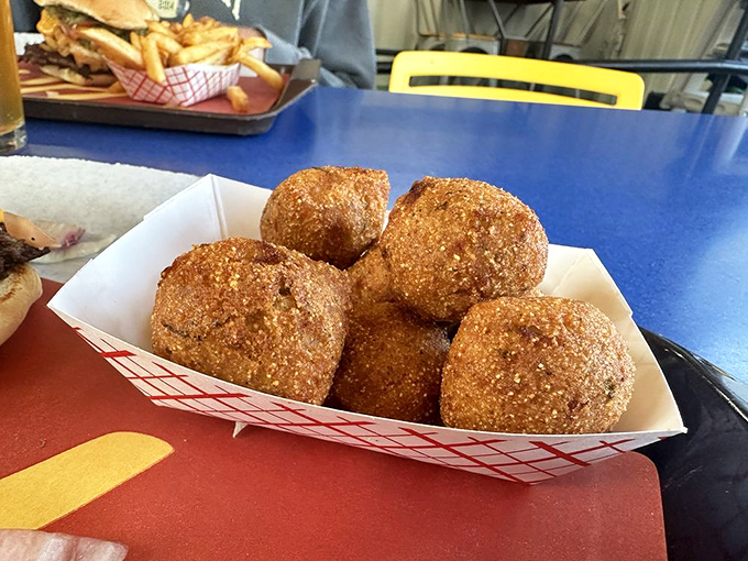 These aren't your grandma's hush puppies—unless your grandma was secretly a culinary rebel. Golden, crispy spheres of jalapeño-spiked joy.
