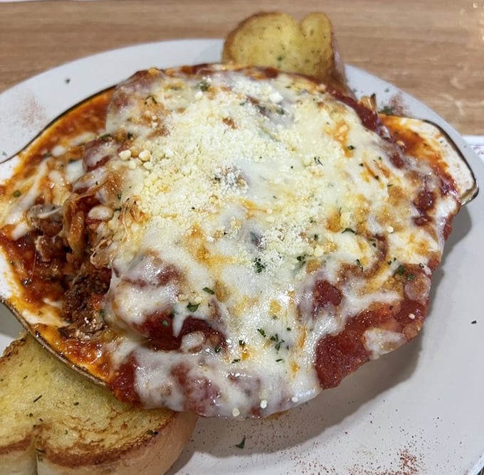 Lasagna that doesn't just sit on the plate—it makes a statement. The melted cheese pulls away in strings that seem to whisper, "Take another bite."