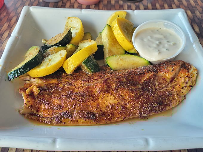 Blackened fish that's perfectly seasoned, not cremated—paired with summer squash that tastes like it was picked this morning from someone's backyard garden.