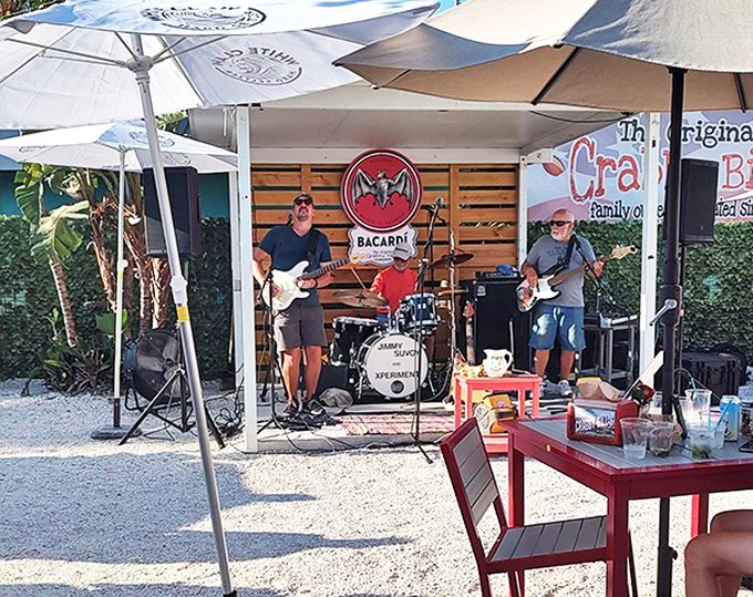 Live music under beach umbrellas creates the soundtrack to your seafood feast – because grouper sandwiches always taste better with a side of island tunes.