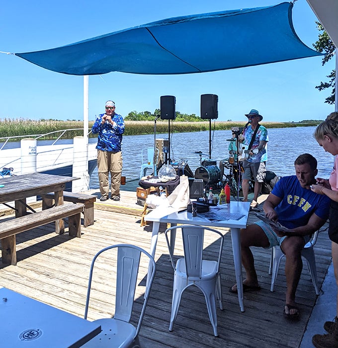 Live music on the dock isn't background noise—it's the soundtrack to memories being made over fresh seafood and cold drinks.