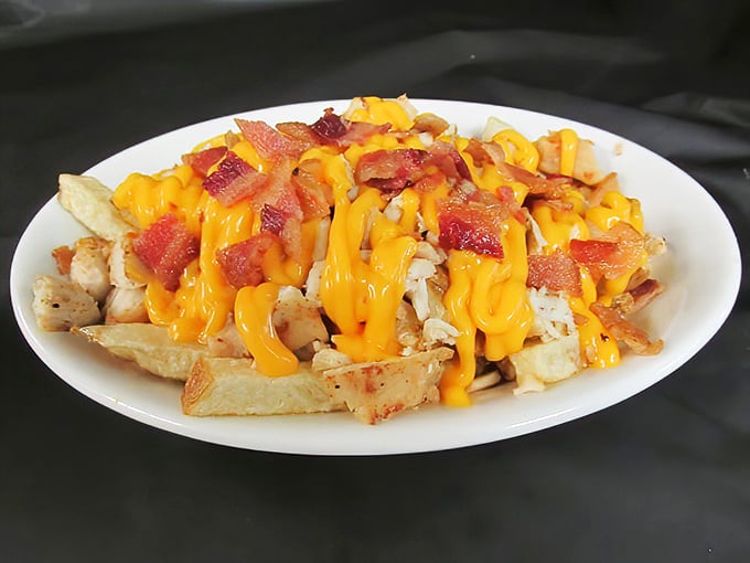 Loaded fries that don't know when to quit—crispy potatoes buried under an avalanche of melted cheese and bacon that would make a cardiologist weep.