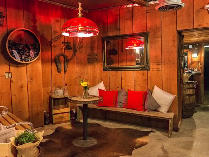 Cozy seating nooks create intimate spaces within the larger restaurant. That red lamp casts the kind of glow that makes everyone look good.