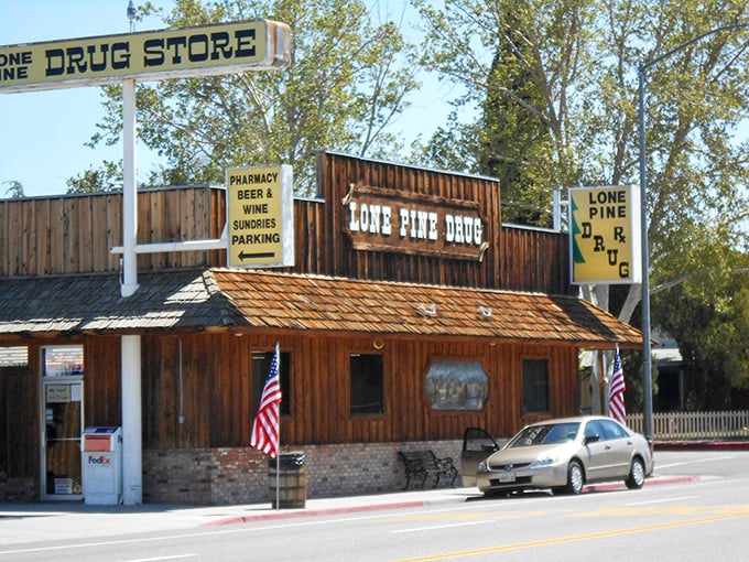 The Lone Pine Drug Store embraces its Western heritage with wooden façade and American flags – part pharmacy, part time machine to the frontier days.