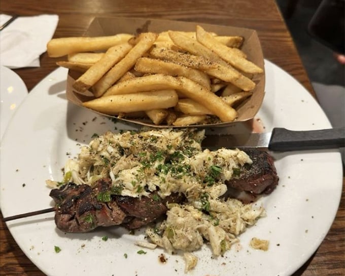 Surf meets turf in perfect harmony—like if Sinatra and Ella Fitzgerald decided to become a steak and crab duet with a side of golden fries. 