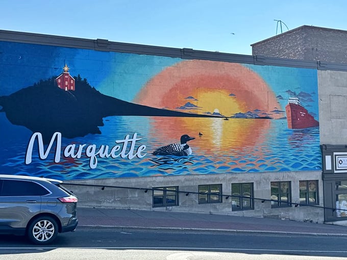 Public art captures Marquette's essence—where lighthouse, loon, and Great Lakes freighter converge under a perfect Superior sunset.