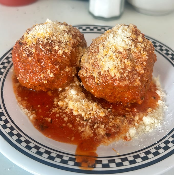 These aren't just meatballs—they're edible time machines to your Italian grandmother's kitchen, swimming in sauce that simmered for hours.