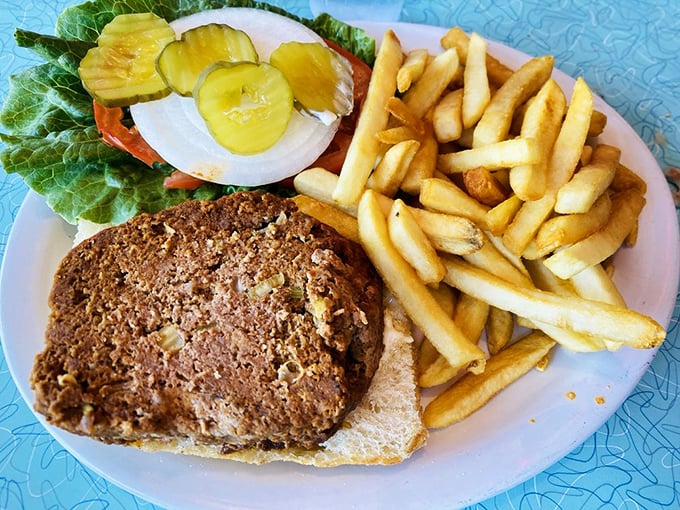 Diner meatloaf isn't just a meal, it's a monument to American comfort food—served with crispy fries and fresh garnish for a plate that satisfies on every level.