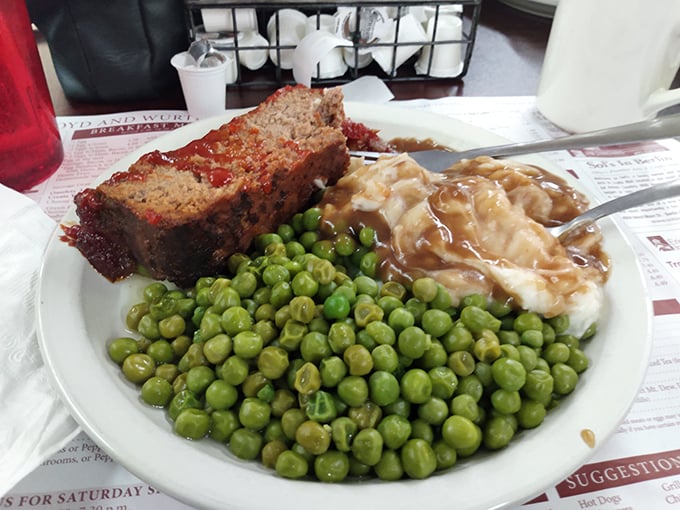 Meatloaf that doesn't apologize for being meatloaf, accompanied by peas so green they could make a vegetable-hater reconsider their life choices.