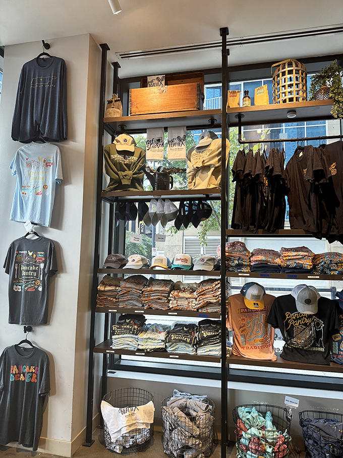 The merchandise wall isn't just souvenirs—it's wearable proof that you survived the line and lived to tell the delicious tale.